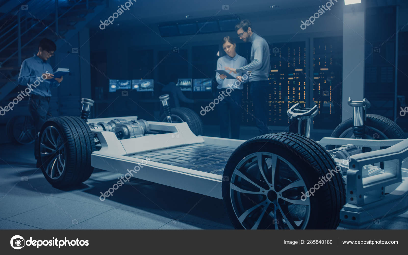 Diverse Automobile Engineers Talking while Working on Electric Car ...