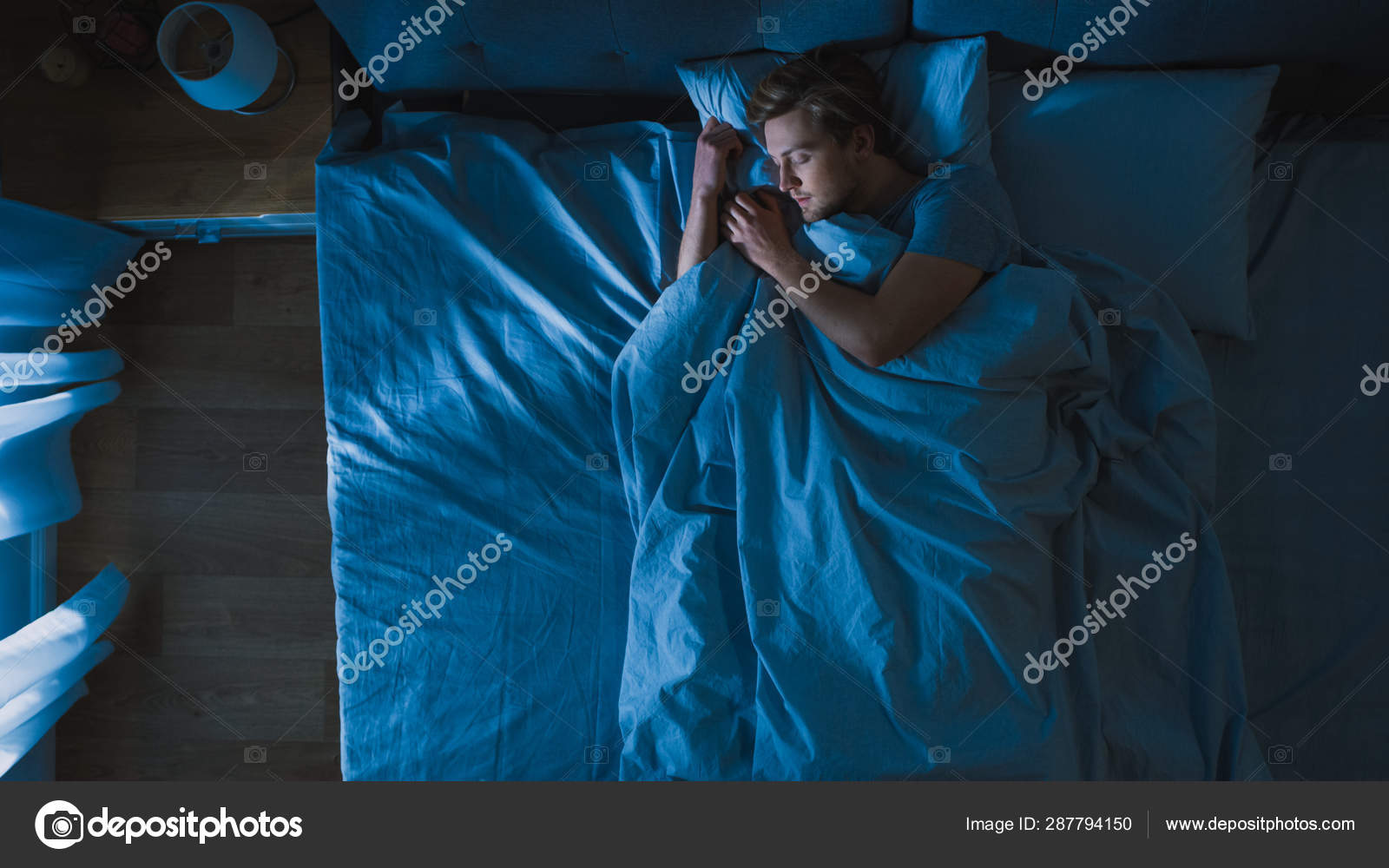Top View of Handsome Young Man Sleeping Cozily on a Bed in His Bedroom ...