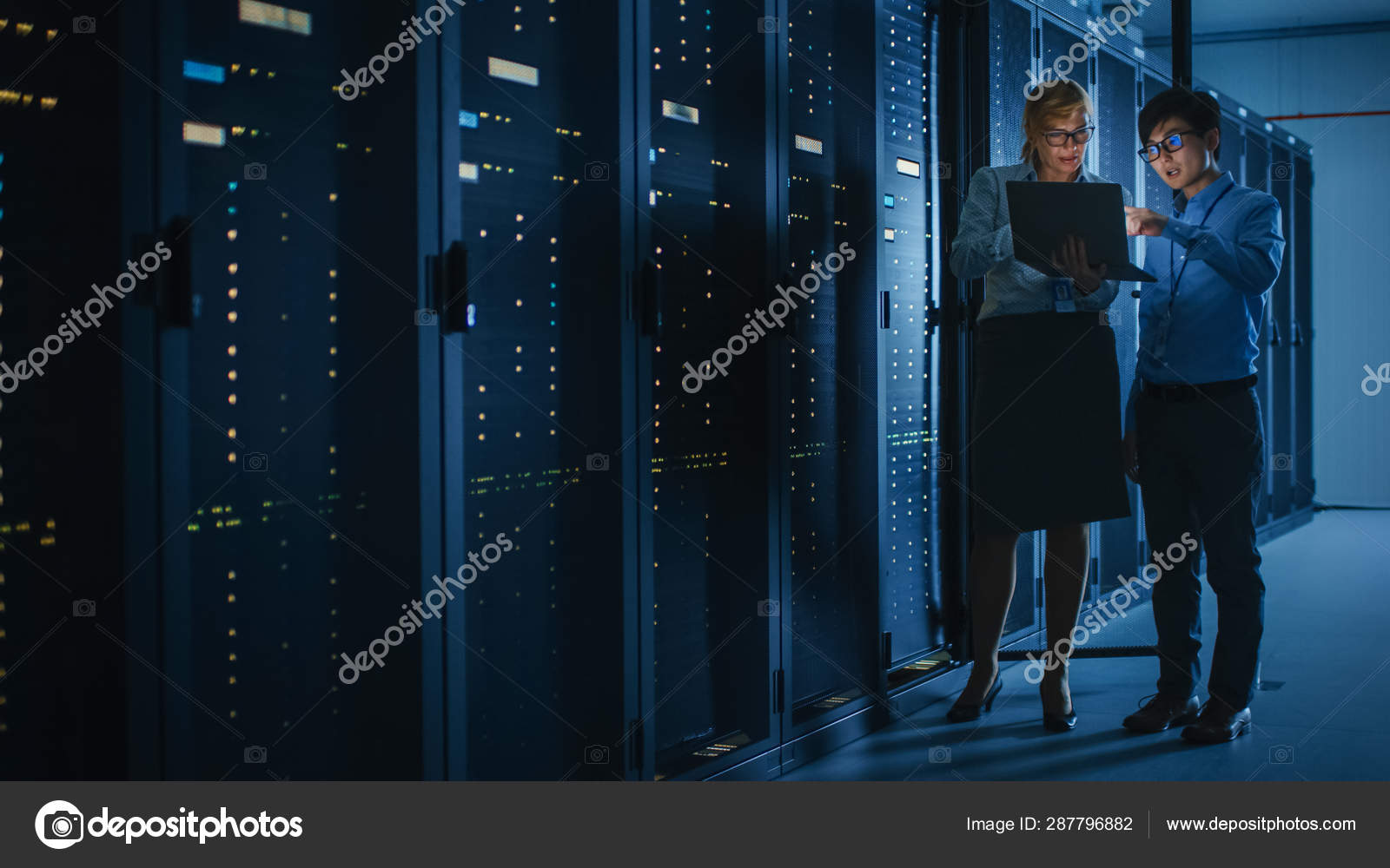 In the Modern Data Center: Engineer and IT Specialist Work with Server ...