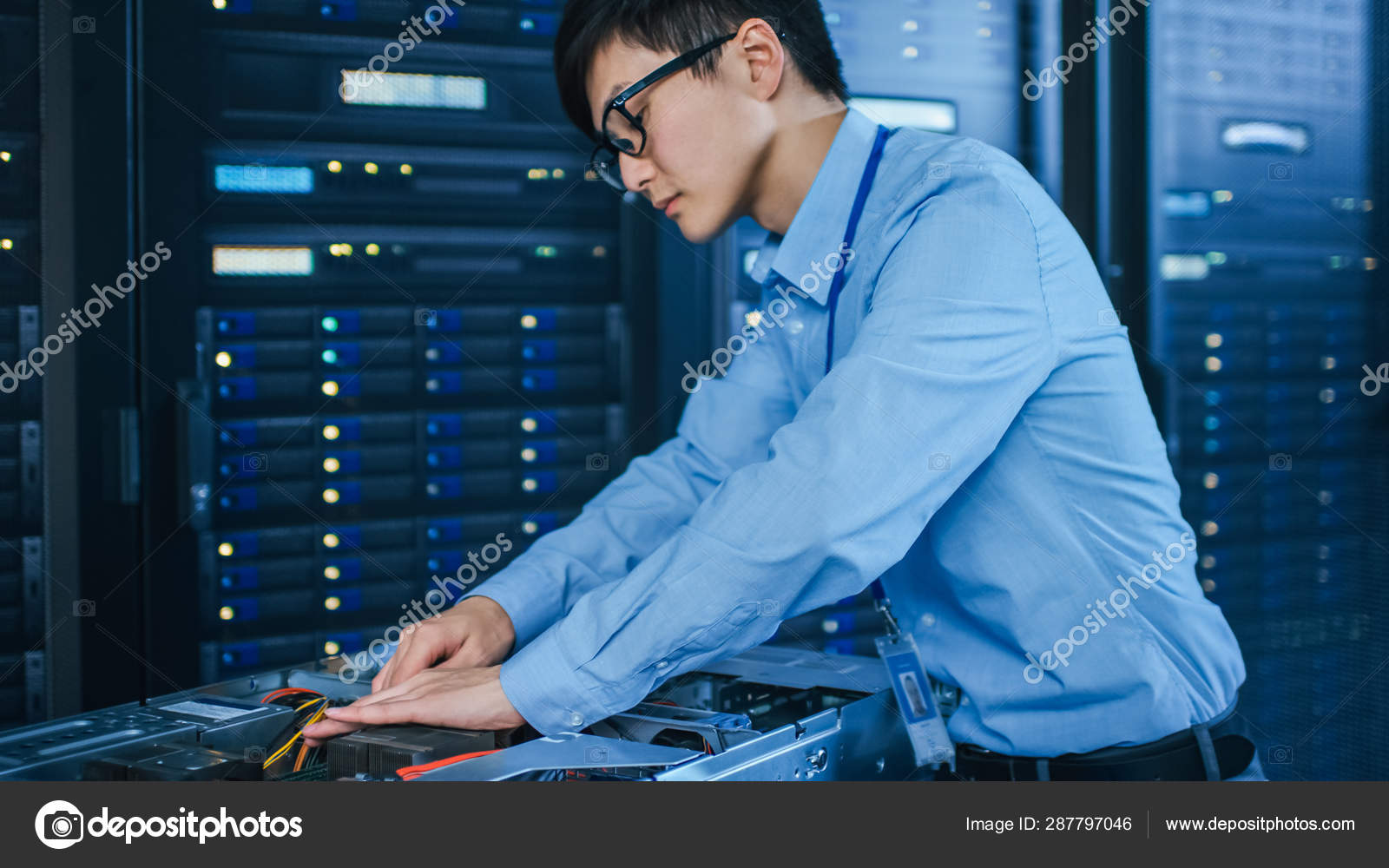 In the Modern Data Center: IT Technician Working with Server Racks, on ...