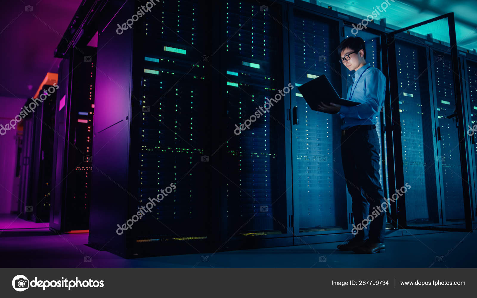 In Data Center: Male IT Technician Running Maintenance Programme on a ...