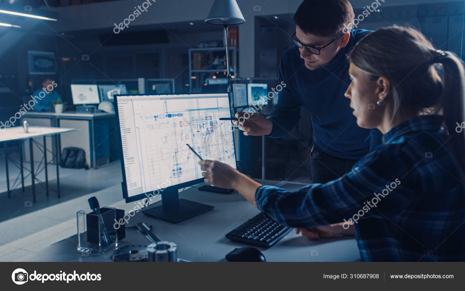 Engineer Working on Desktop Computer, Screen Showing CAD Software with ...