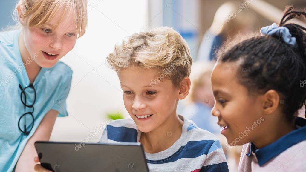 Elementary School Computer Science Class: Two Girls and Boy Use Digital ...