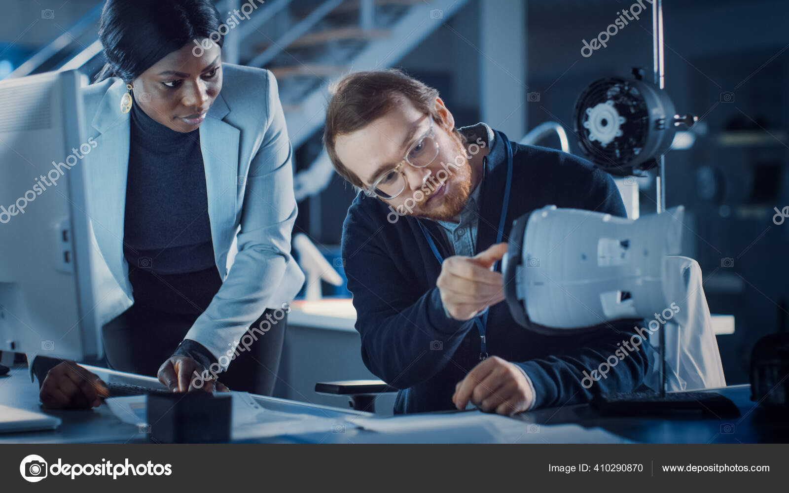 Electronics Development Engineer Working at His Desk, Talks with ...