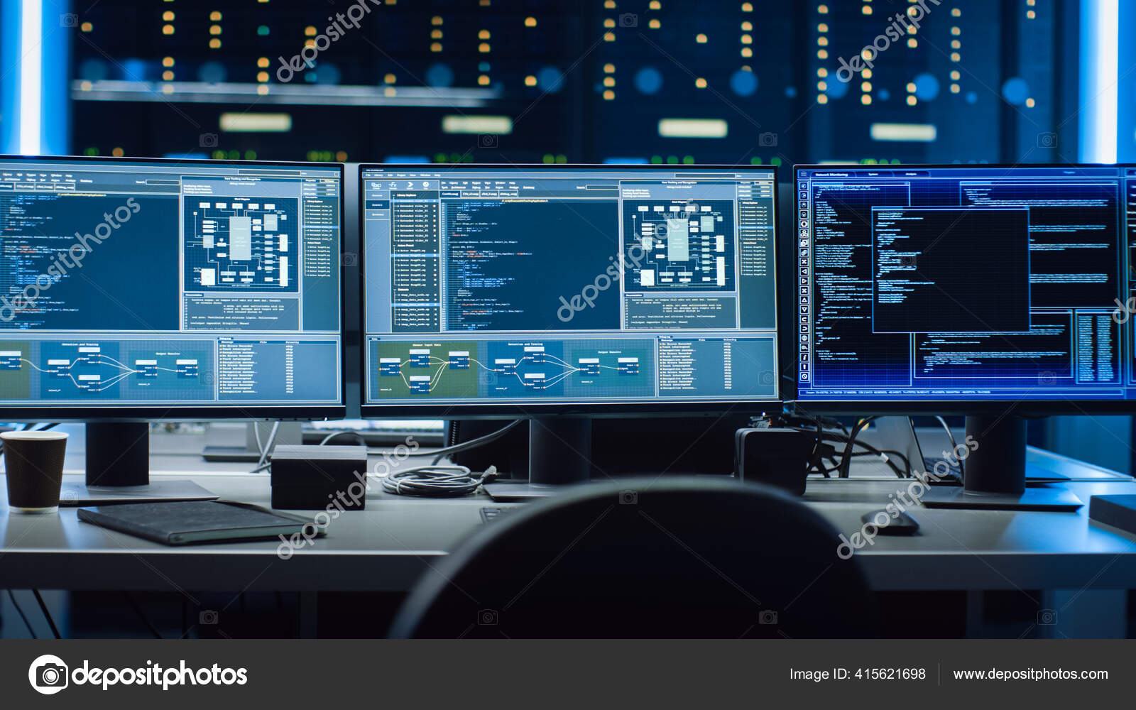 Shot Of Multiple Personal Computer Monitors Showing Coding Language Program With System
