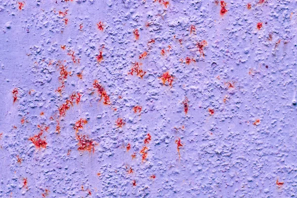 Closeup view of old weathered lilac texture with red patches. Paint and ...