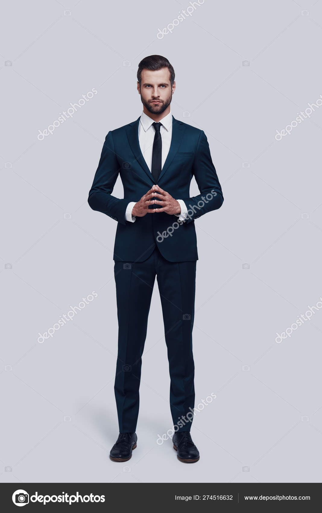 Always perfect. Full length of handsome young man looking at camera and ...