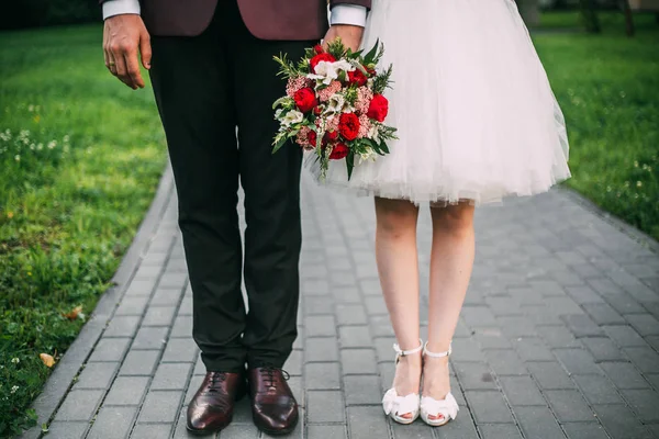 bride and groom without faces are standing on the road - Stock Image ...