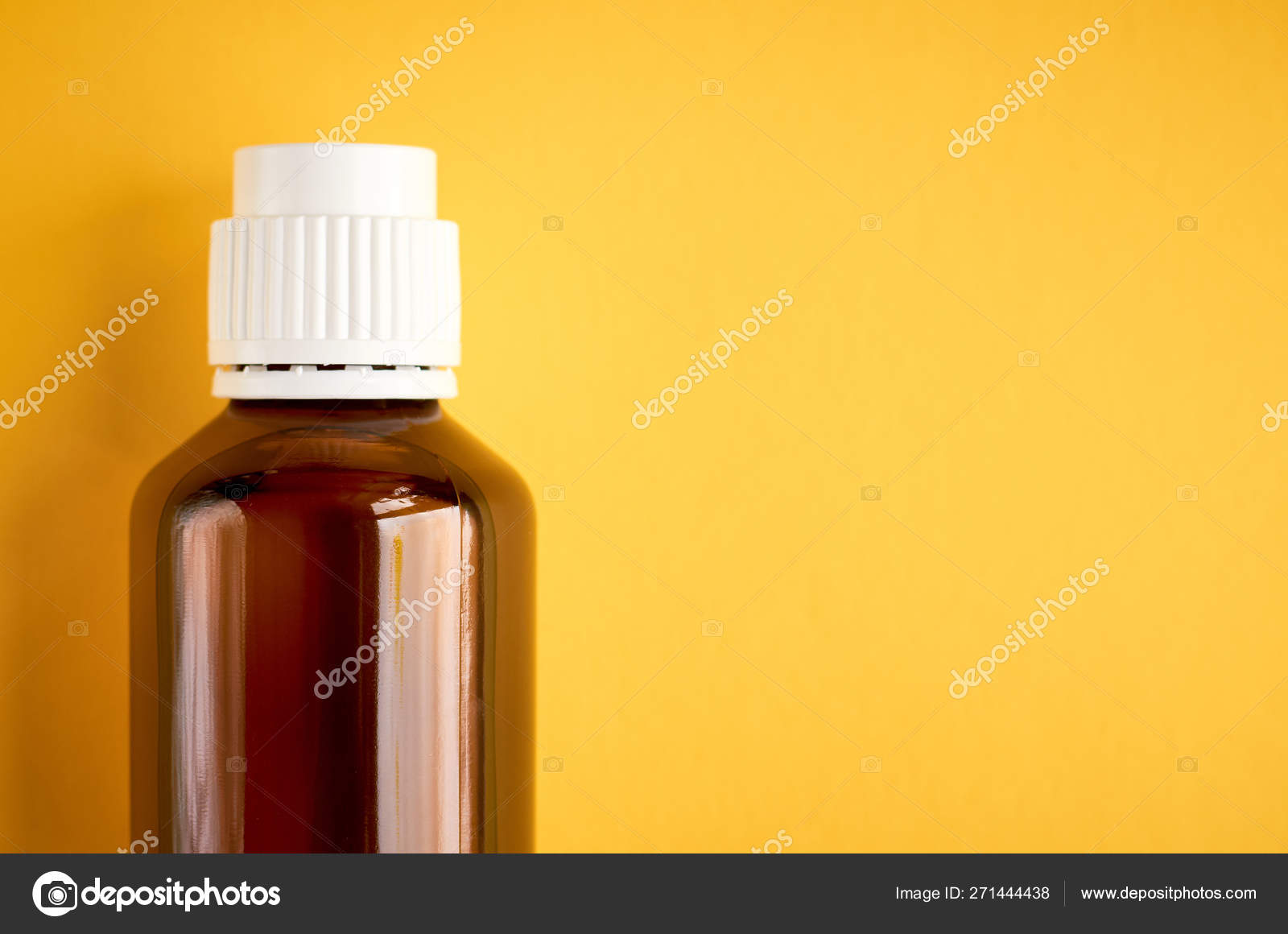 Syrup in glass bottle composition on yellow background Stock Photo by ...