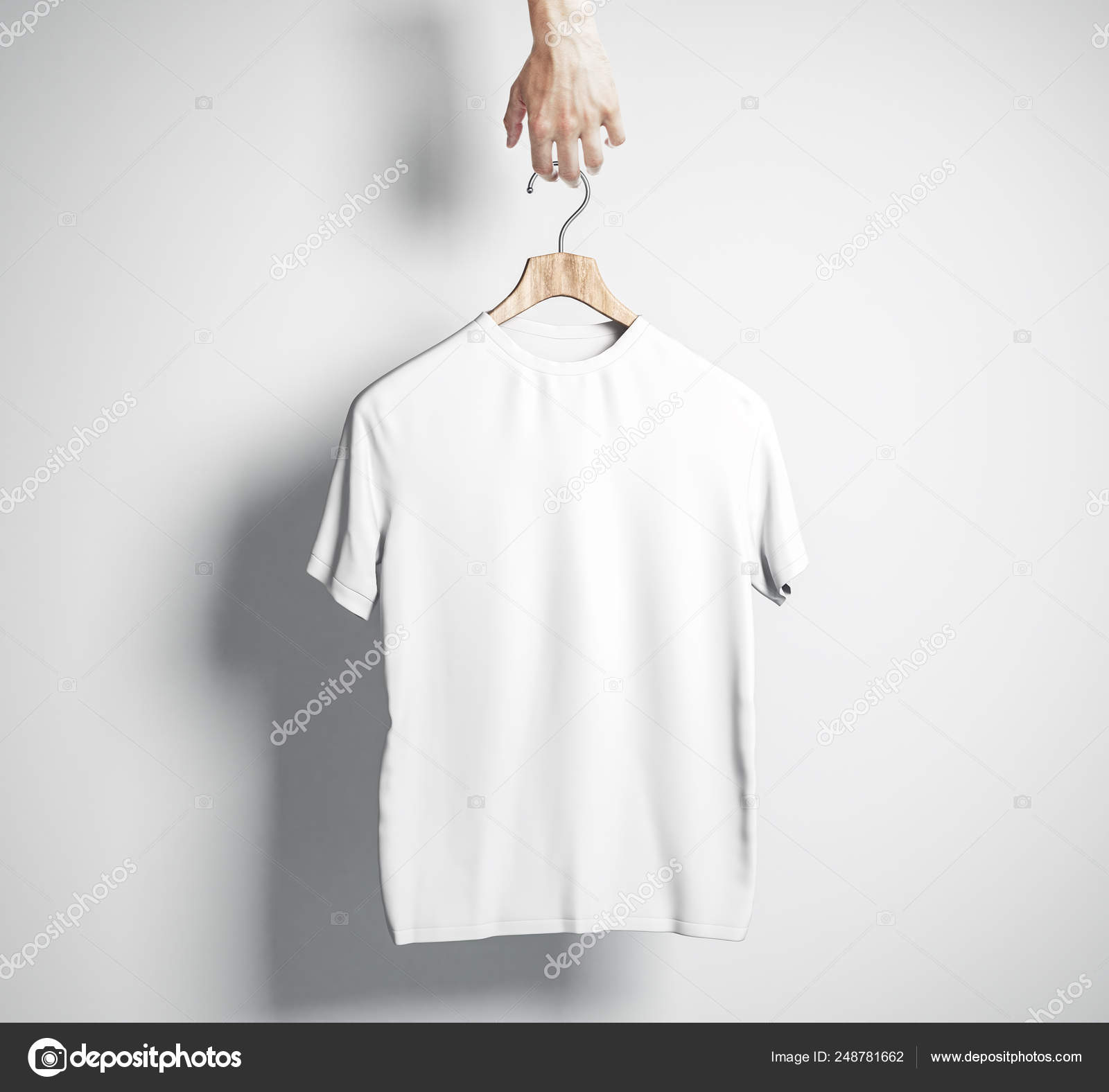 Hand holding empty white shirt Stock Photo by ©peshkov 248781662