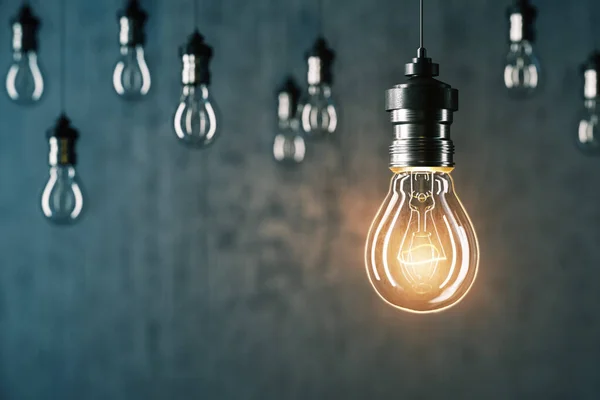 Glowing light bulb and many light bulbs on gray background. Leadership ...
