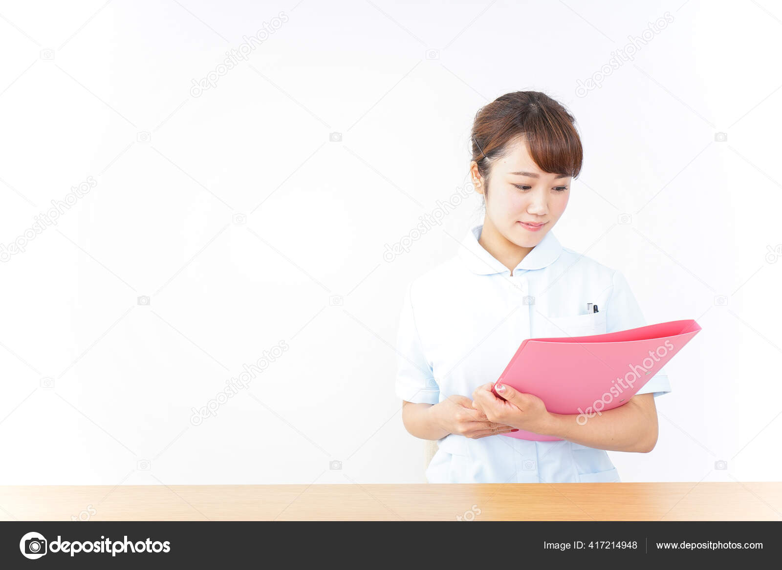 Young Asian Nurse Holding Folder — Stock Photo © maroke #417214948