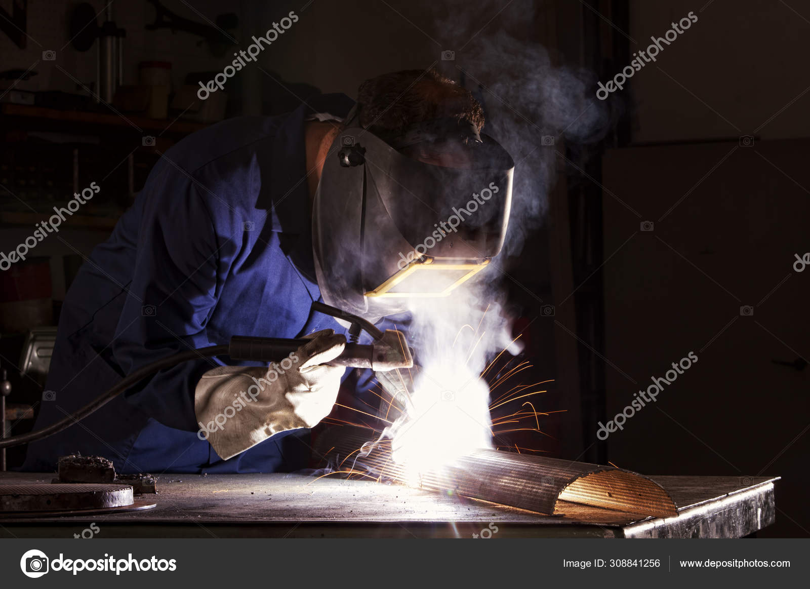 Worker welding in workshop. Stock Photo by ©lichtmeister 308841256
