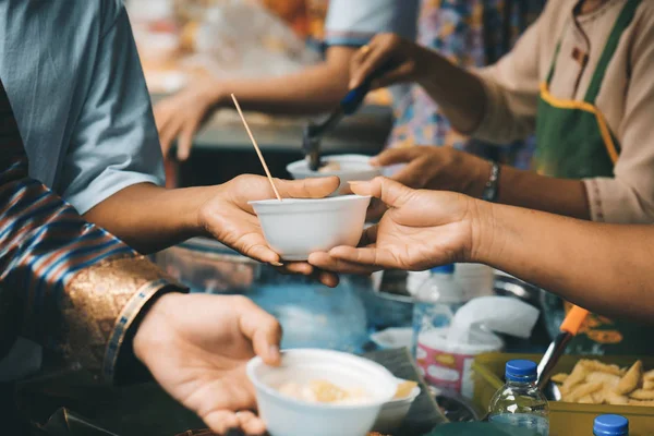 Homeless and needy people receive help, receive food from volunteers ...