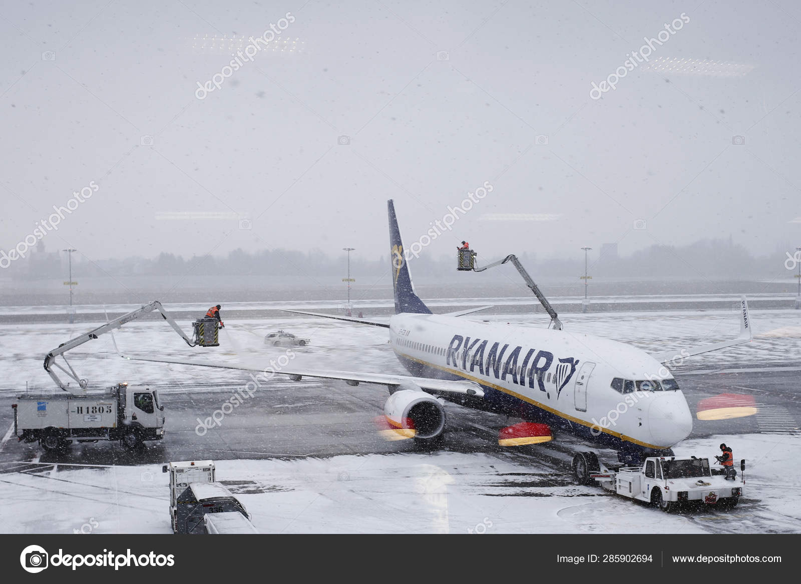 Airplanes on the runway are covered by snow during a snowfall at ...