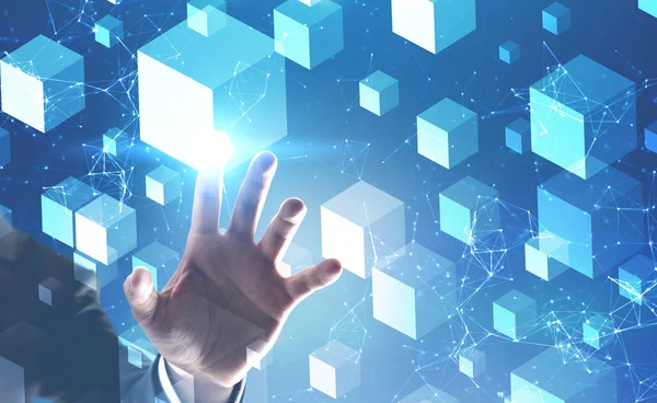 Hand of businessman touching white cubes over blue background and ...