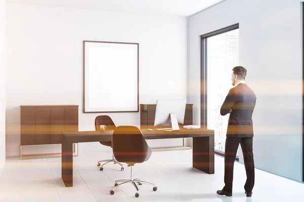 Businessman in corner of manager office with white walls, tiled floor ...