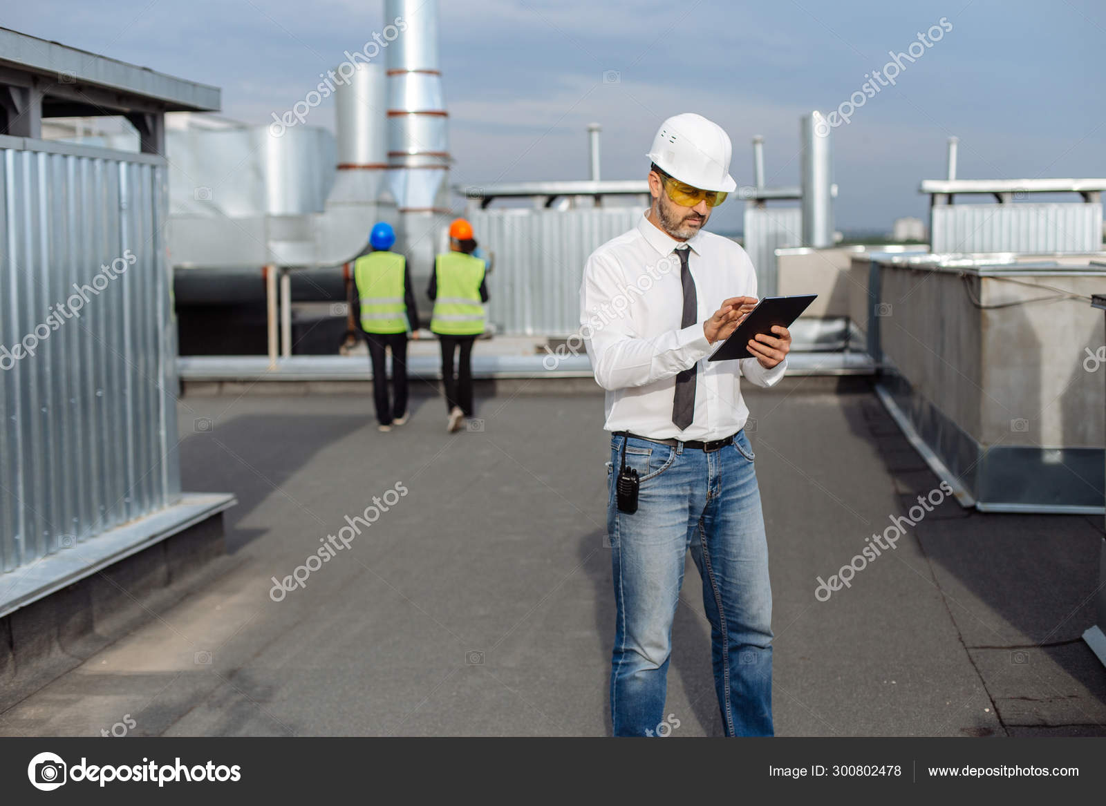 On the rooftop of construction site man engineer make a conversation ...