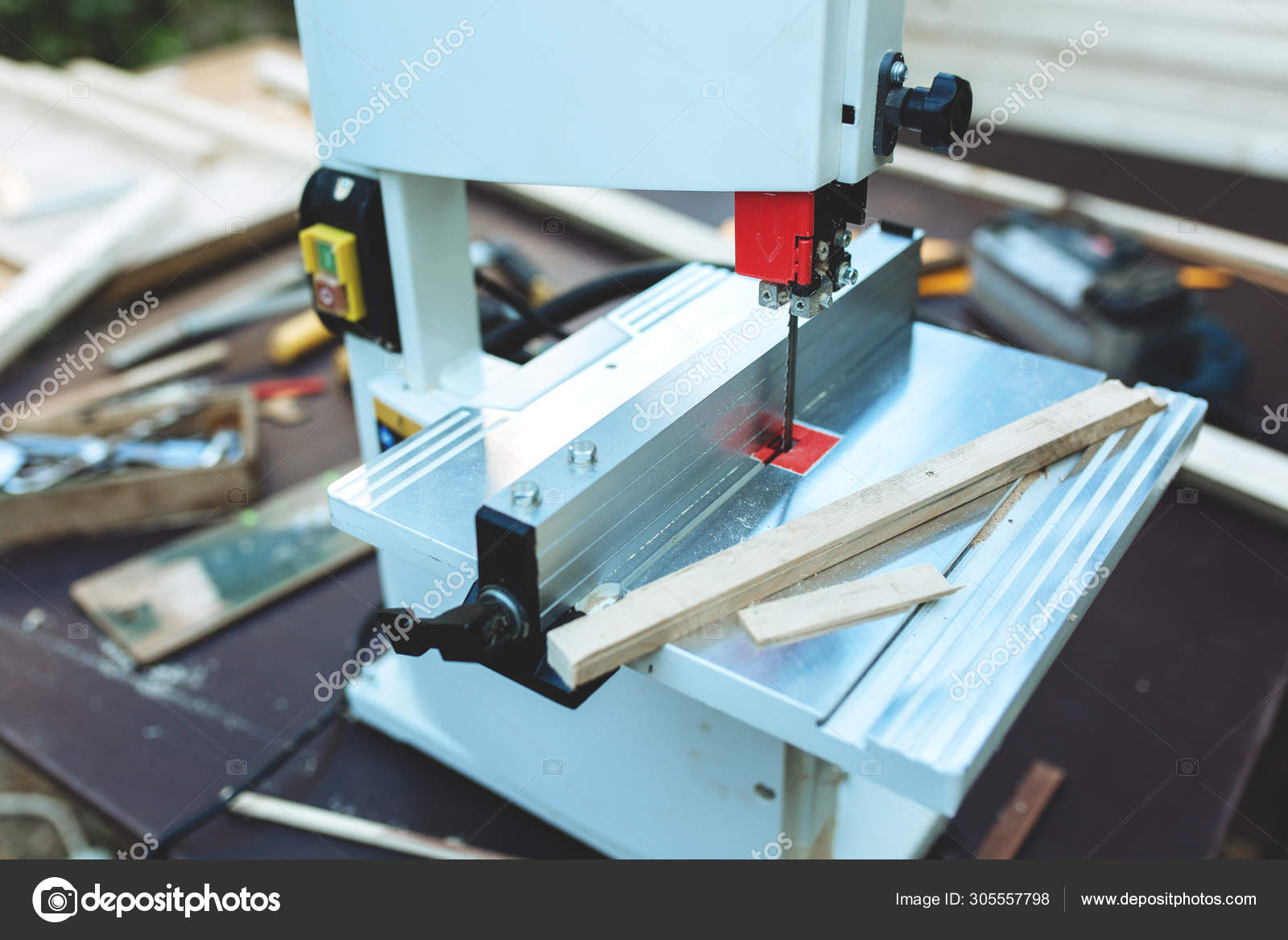 Carpenter uses a linear saw to cut wooden beams outdoors for ...
