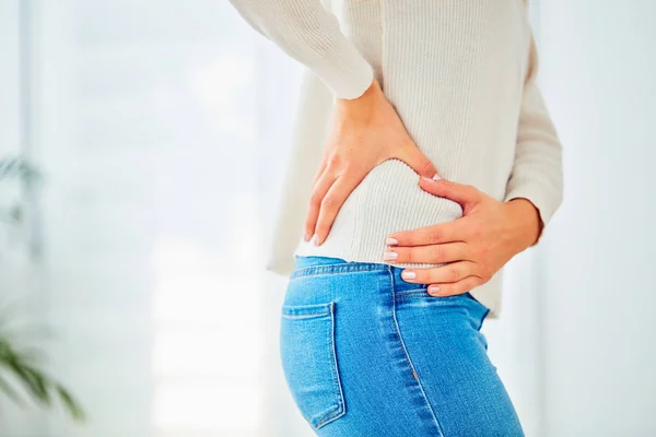 Woman with hip, back and spinal problems. - Stock Image - Everypixel