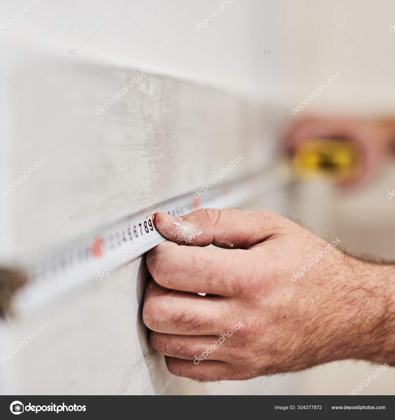 Worksman using tape measure for home renovation. — Stock Photo ...