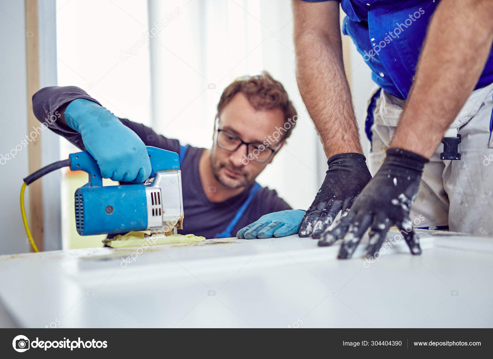 Two handymen working together on a house renovation. Stock Photo by ...