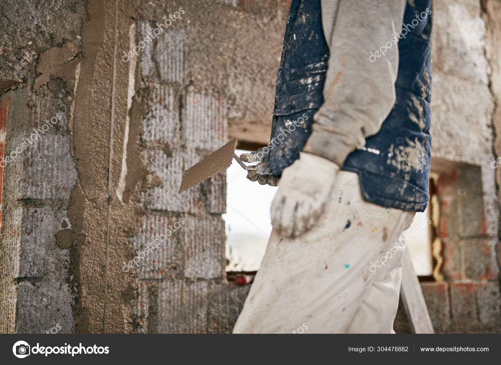 Real construction worker making a wall inside the new house. Stock ...