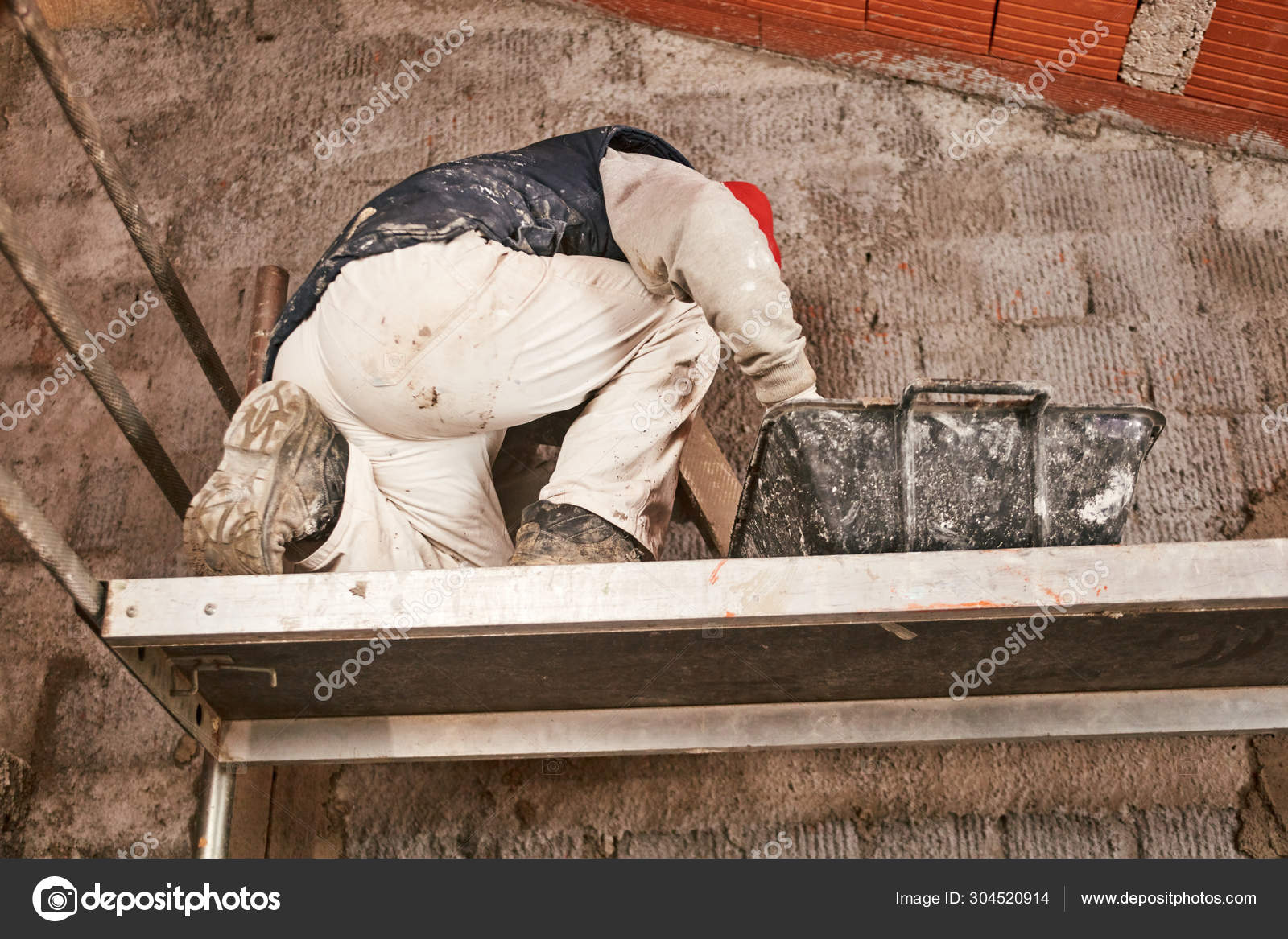 Real construction worker making a wall inside the new house. Stock ...
