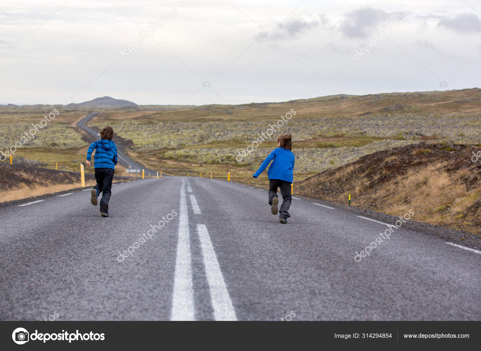 Kids running on an empty road in beautiful nature in Snaefellsjo Stock ...