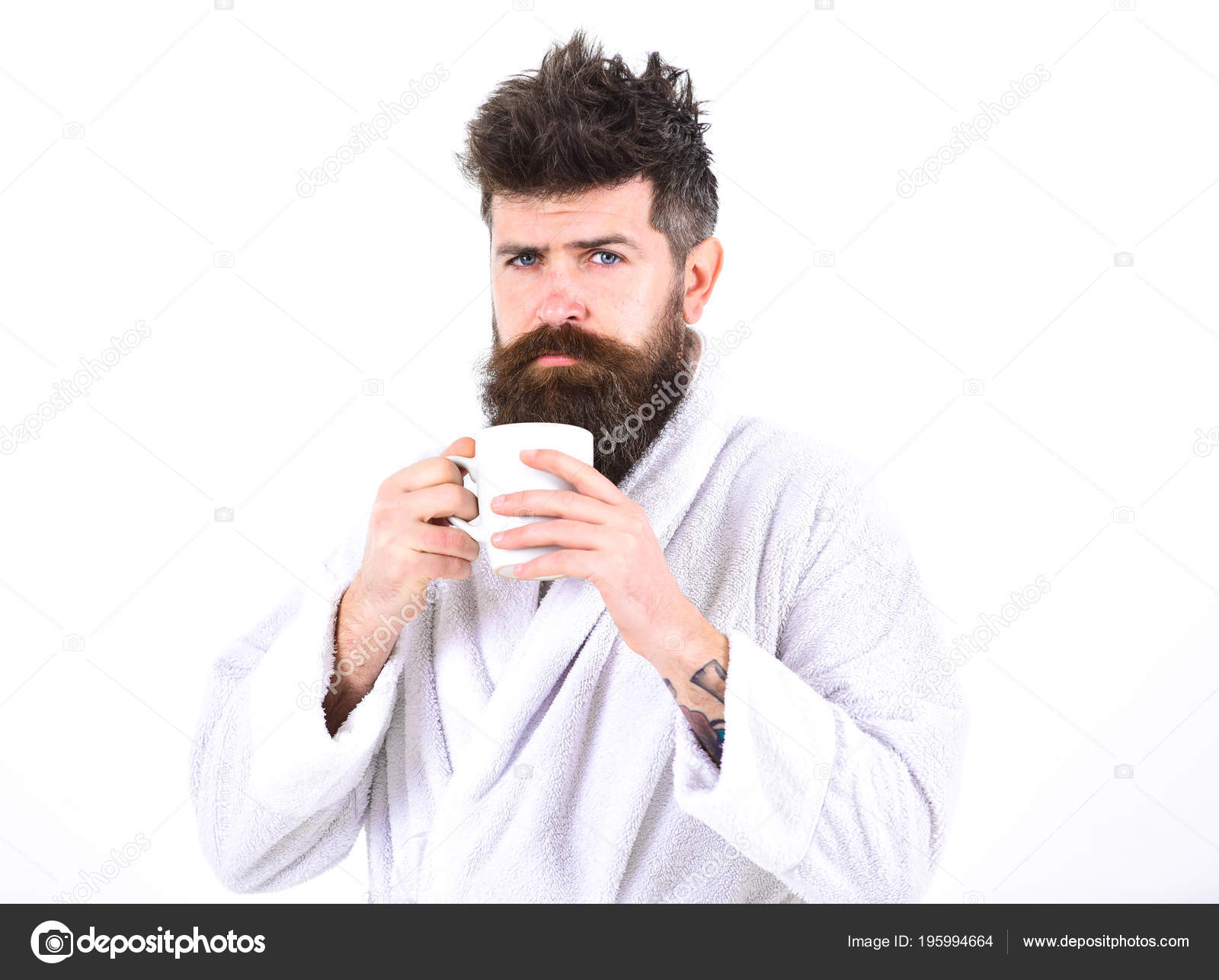 Macho drowsy, sleepy with strict face drinks coffee in morning. Morning ...