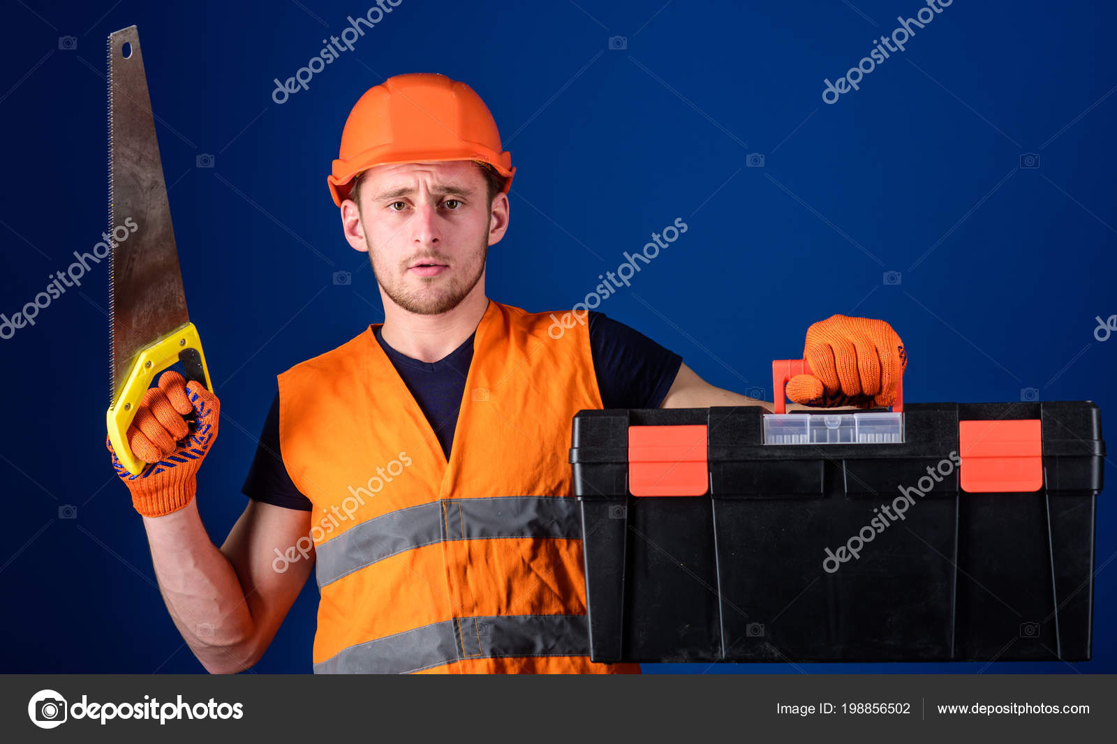 Carpenter concept. Man in helmet, hard hat carries toolbox and holds ...