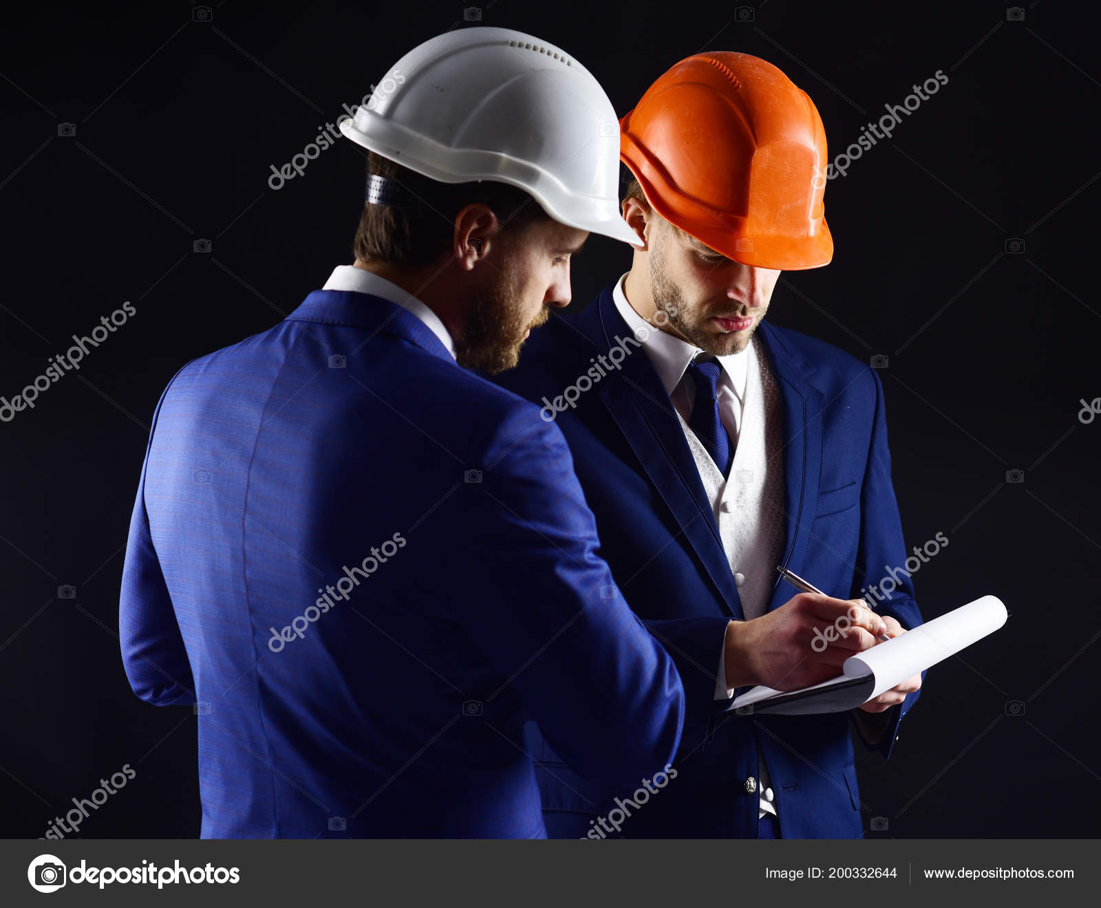 Builders think about engineering project. Stock Photo by ©stetsik 200332644