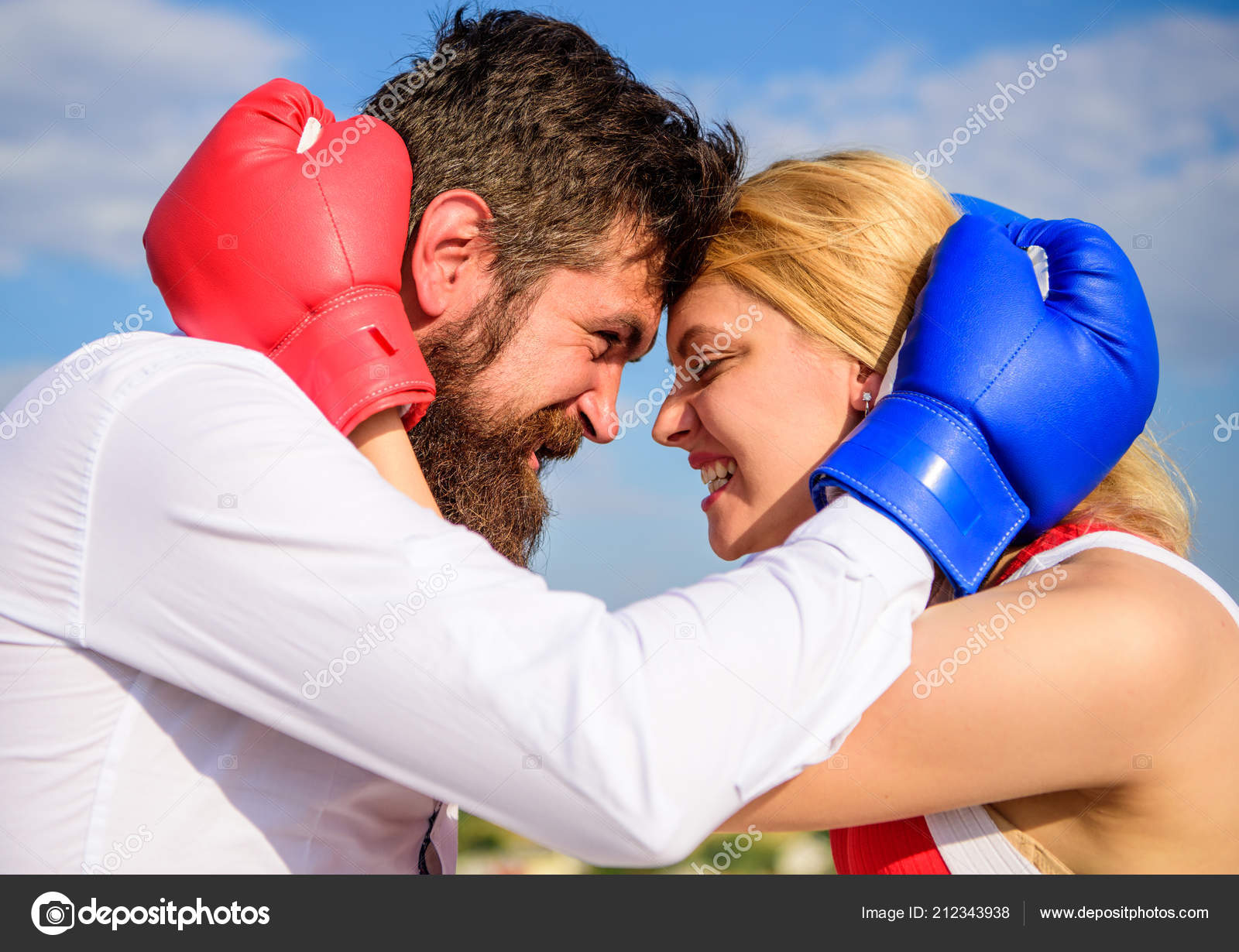 Fight for your happiness. Couple in love boxing gloves hug blue sky ...