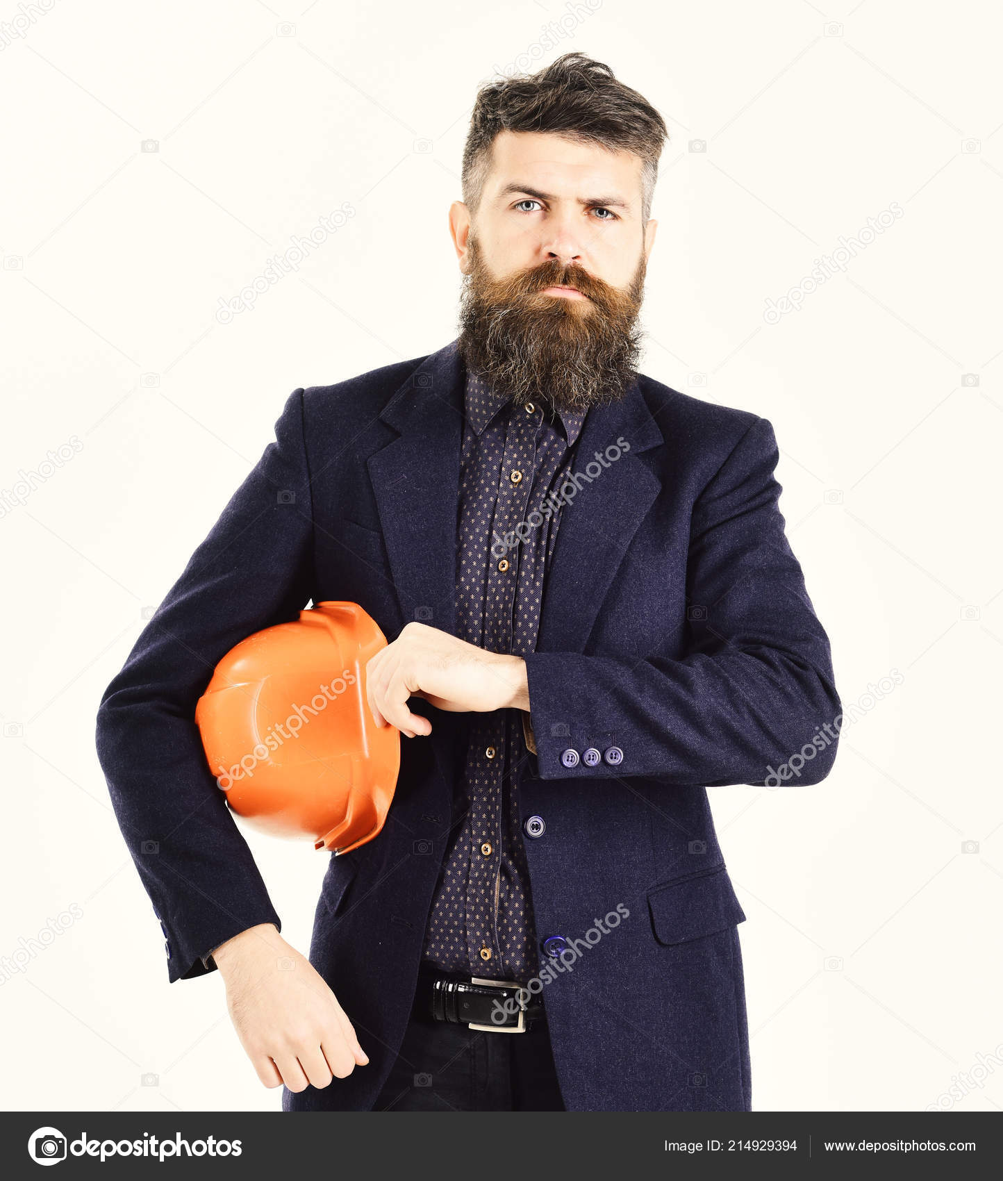 Man with beard and serious face looks. Building and engineering concept ...