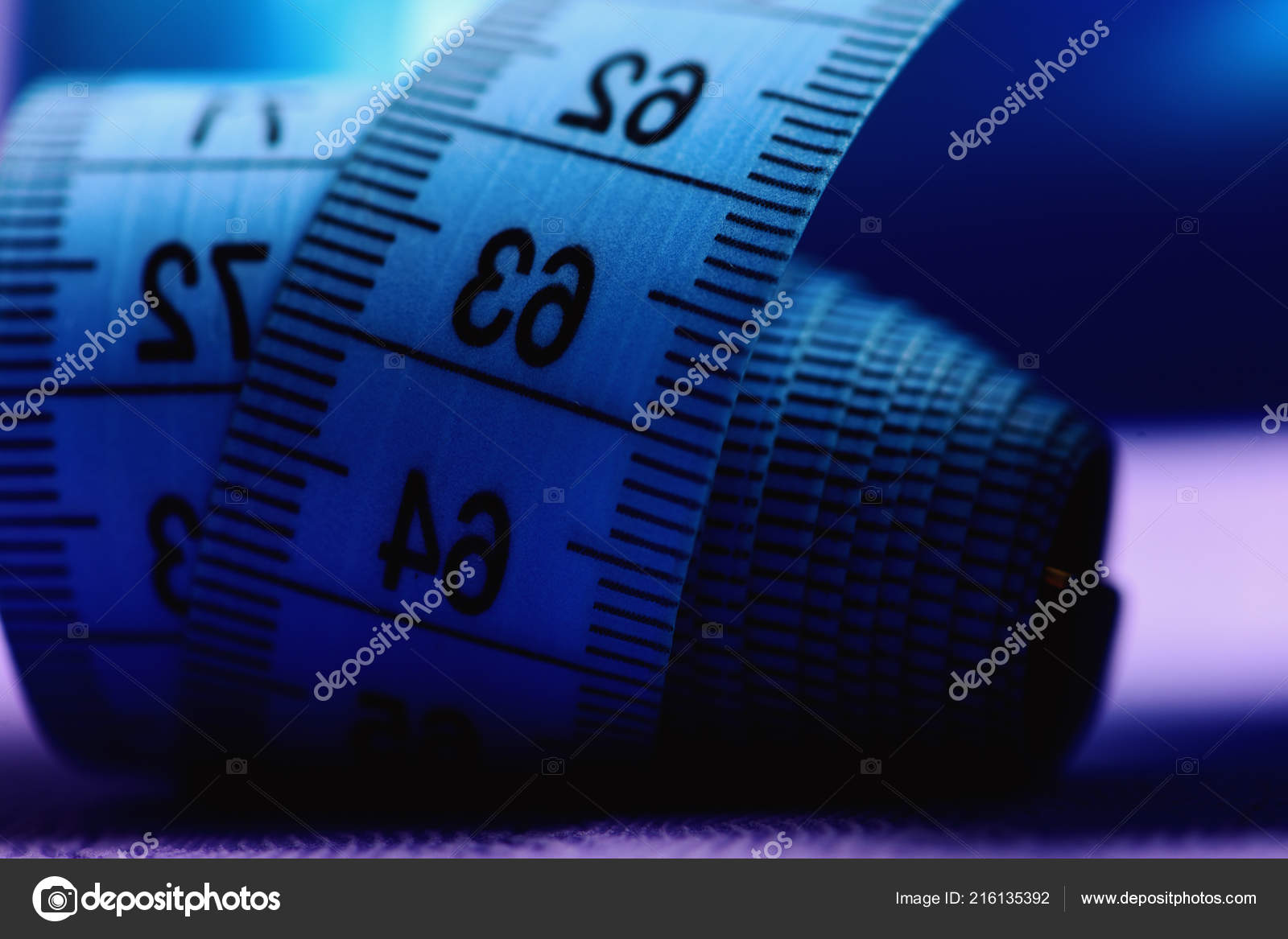 Measure tape in deep blue color on blue background, defocused. Stock ...