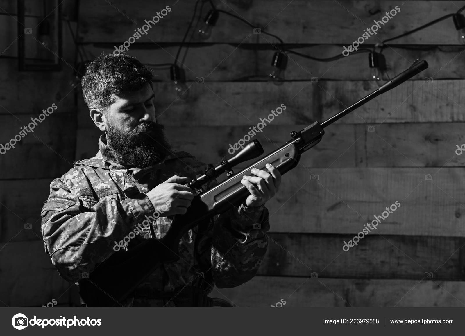 Macho on strict face at gamekeepers house. Huntsman concept. Man with ...
