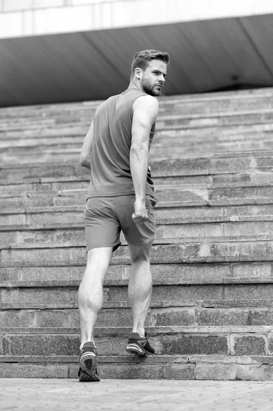 Energy concept. Strong man full of energy. Sportsman run upstairs with ...