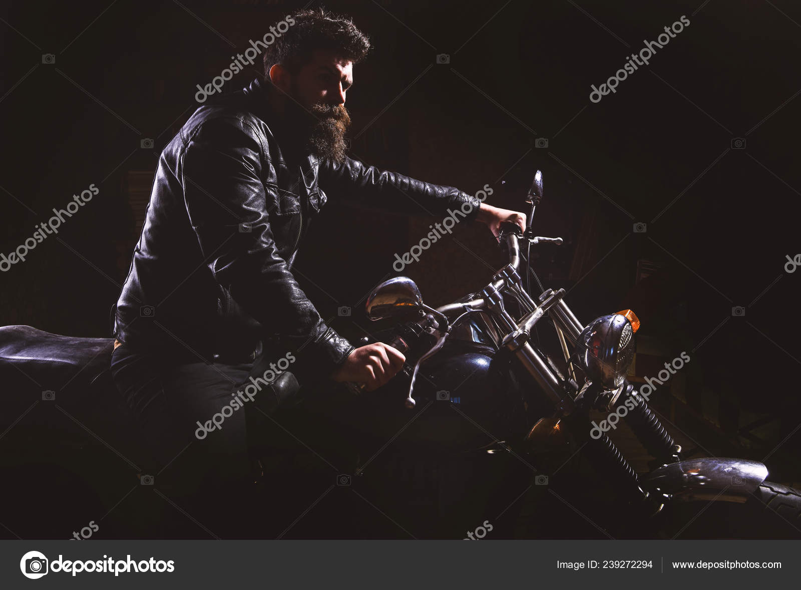 Man with beard, biker in leather jacket sitting on motor bike in ...