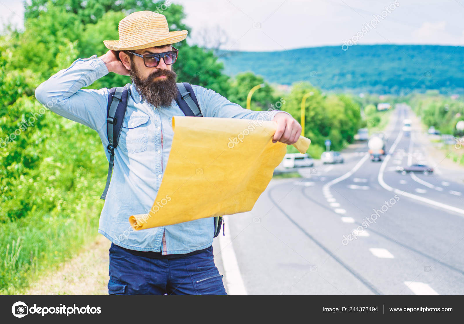 Carry good map. Tourist backpacker looks at map choosing travel ...
