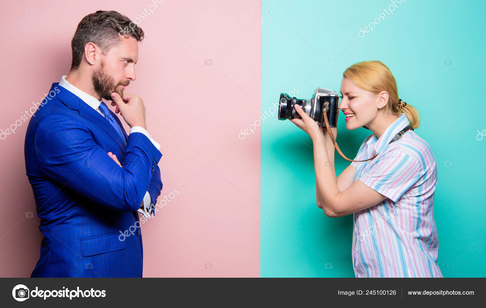 Capturing the confidence. Businessman posing in front of female ...