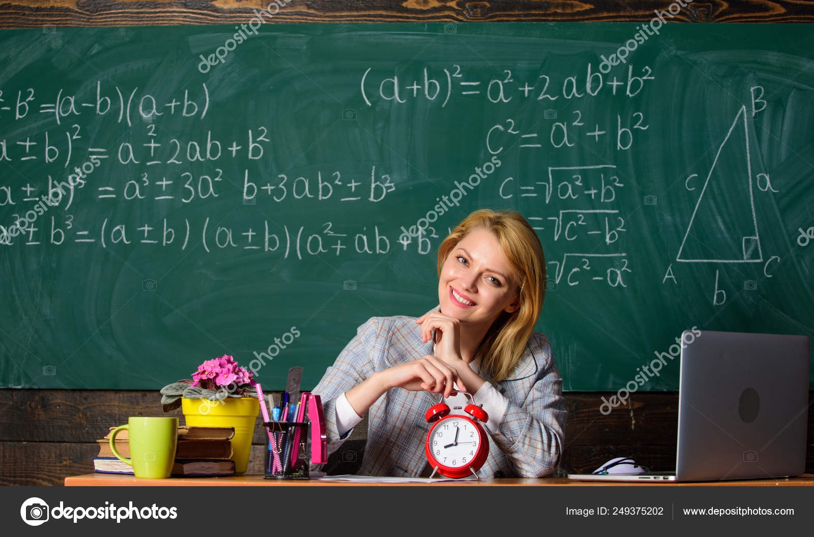 Take your time. teacher with alarm clock at blackboard. Time. Study and ...