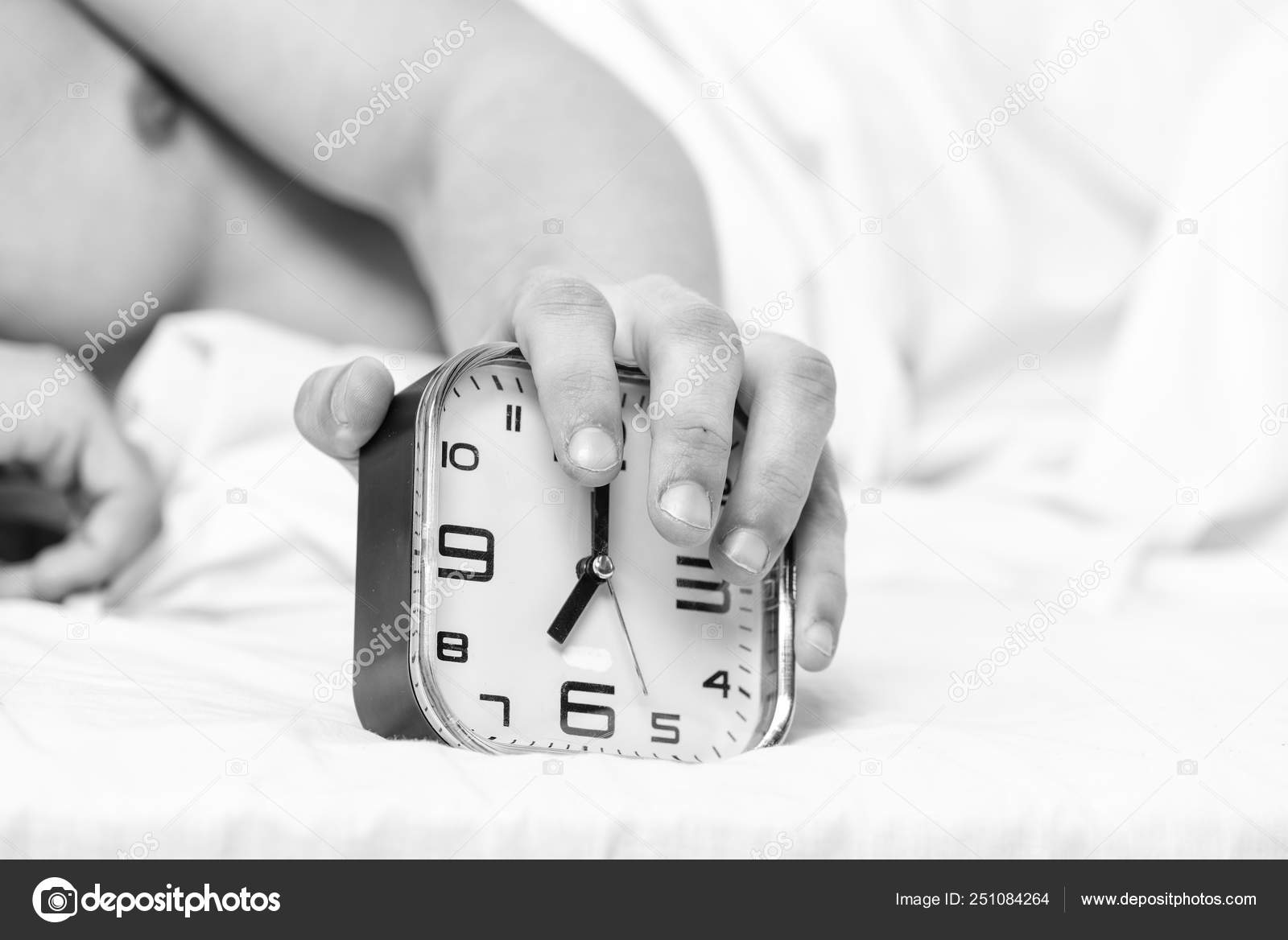 Lazy man happy waking up in the bed rising hands in the morning with ...