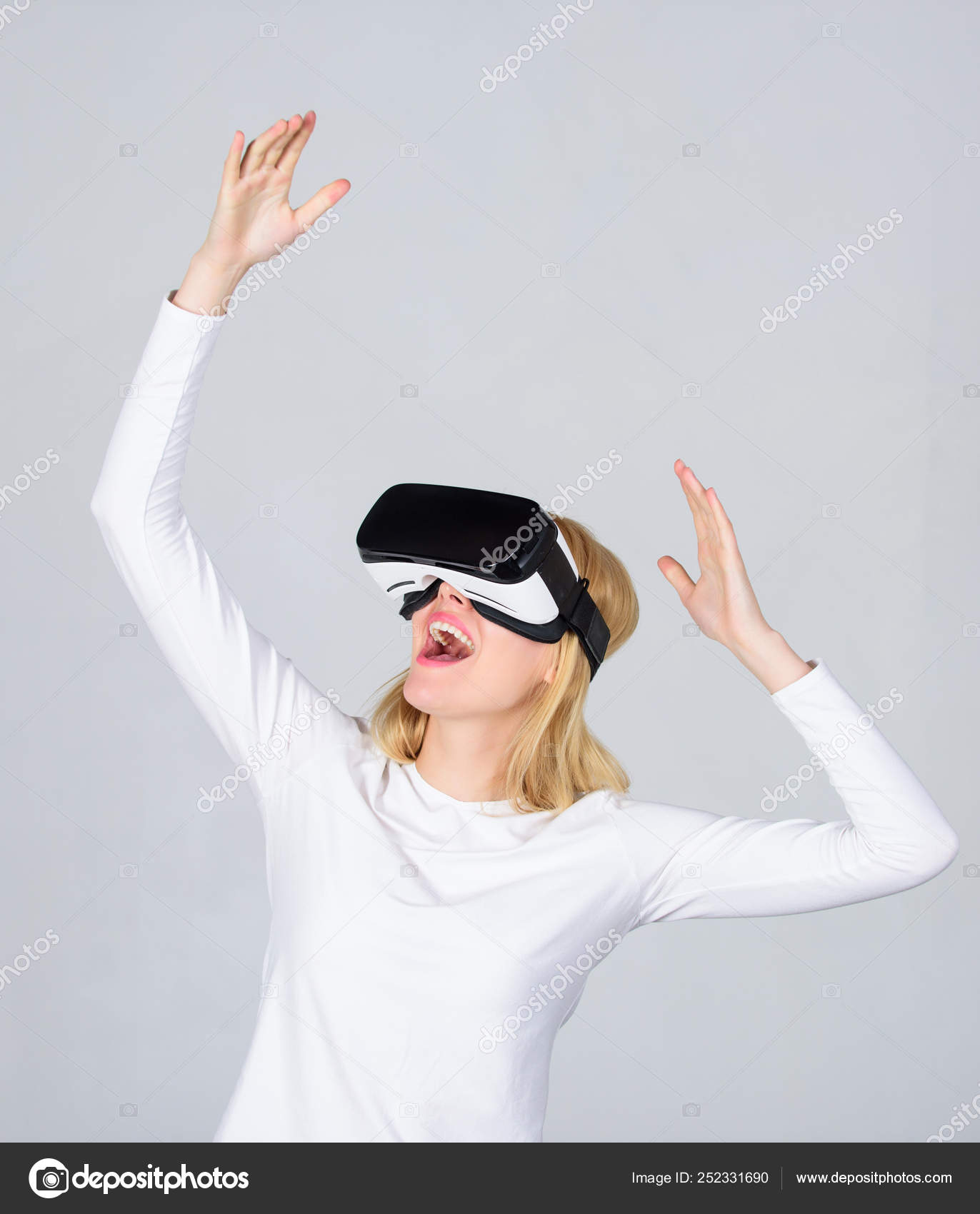 Portrait of young woman wearing VR goggles, experiencing virtual reality using 3d headset. Happy ...
