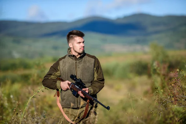 Bearded hunter spend leisure hunting. Hunter hold rifle. Focus and ...