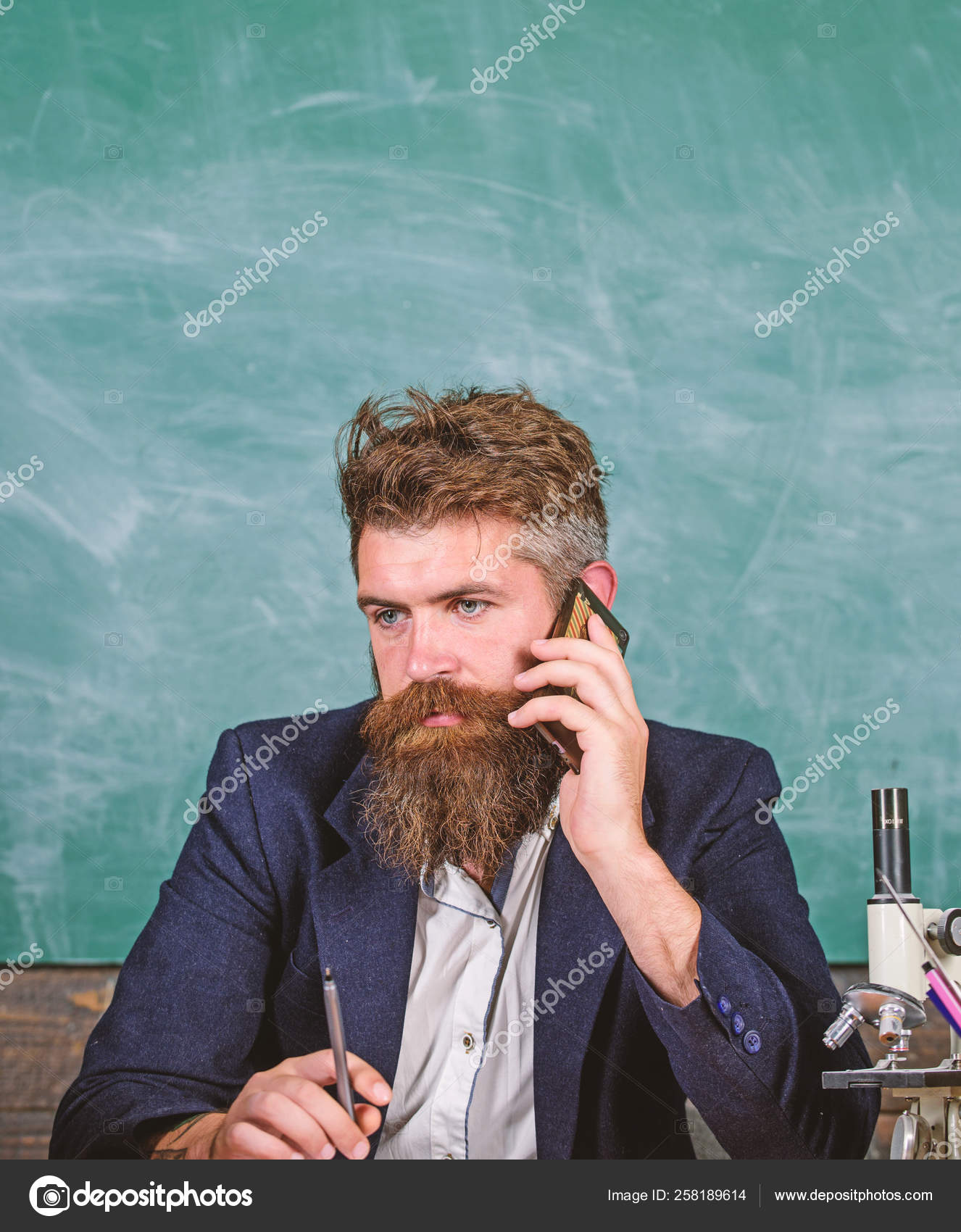 Keep in touch. School teacher call mobile phone while sit classroom ...