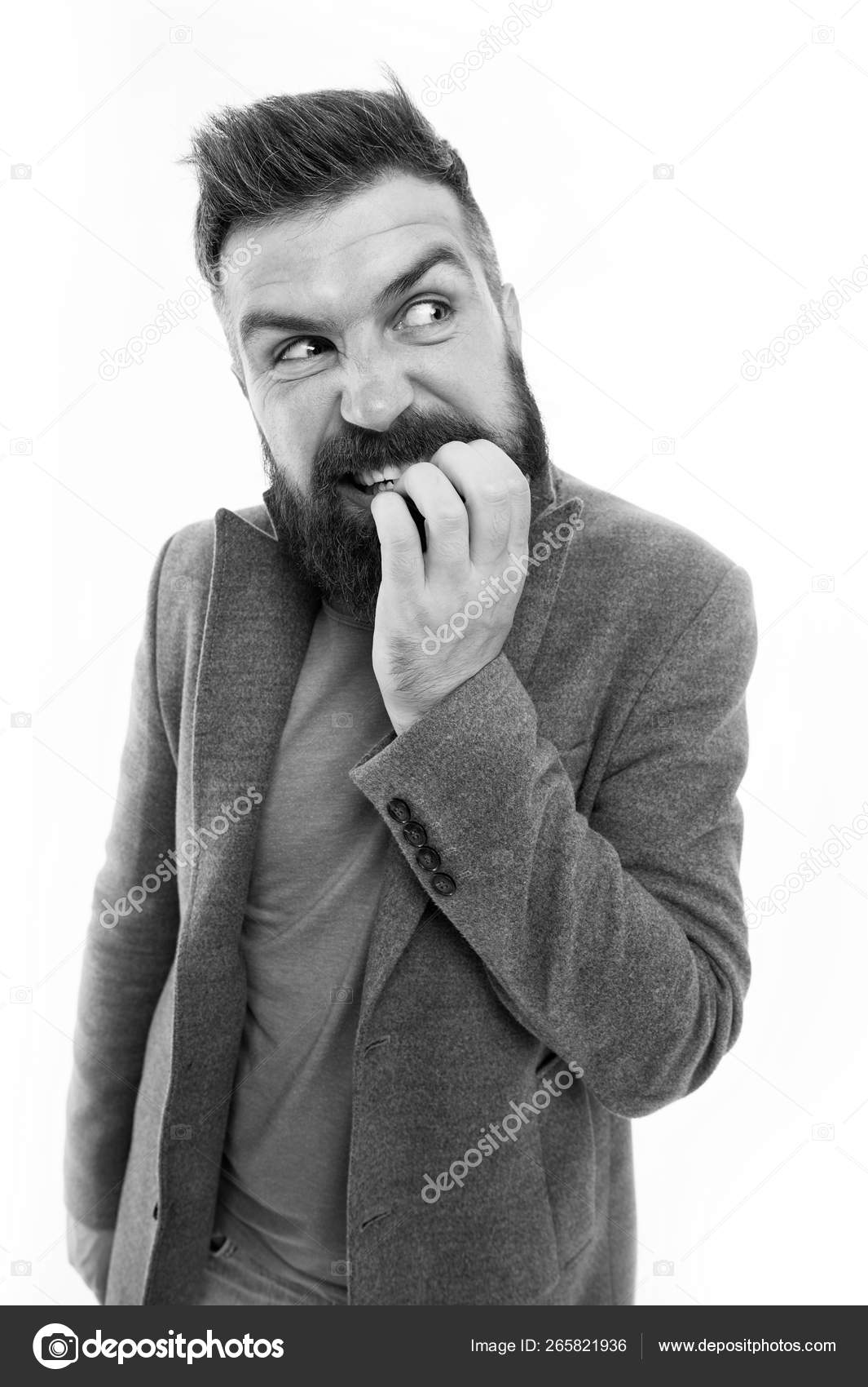 Man bearded hipster doubtful face bites finger while thinking. Nervous ...