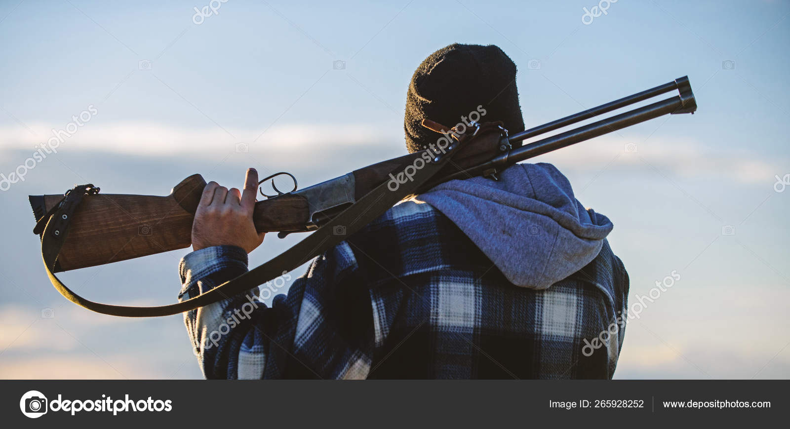 Brutality and masculinity. Hunter carry rifle gun on shoulder rear view ...