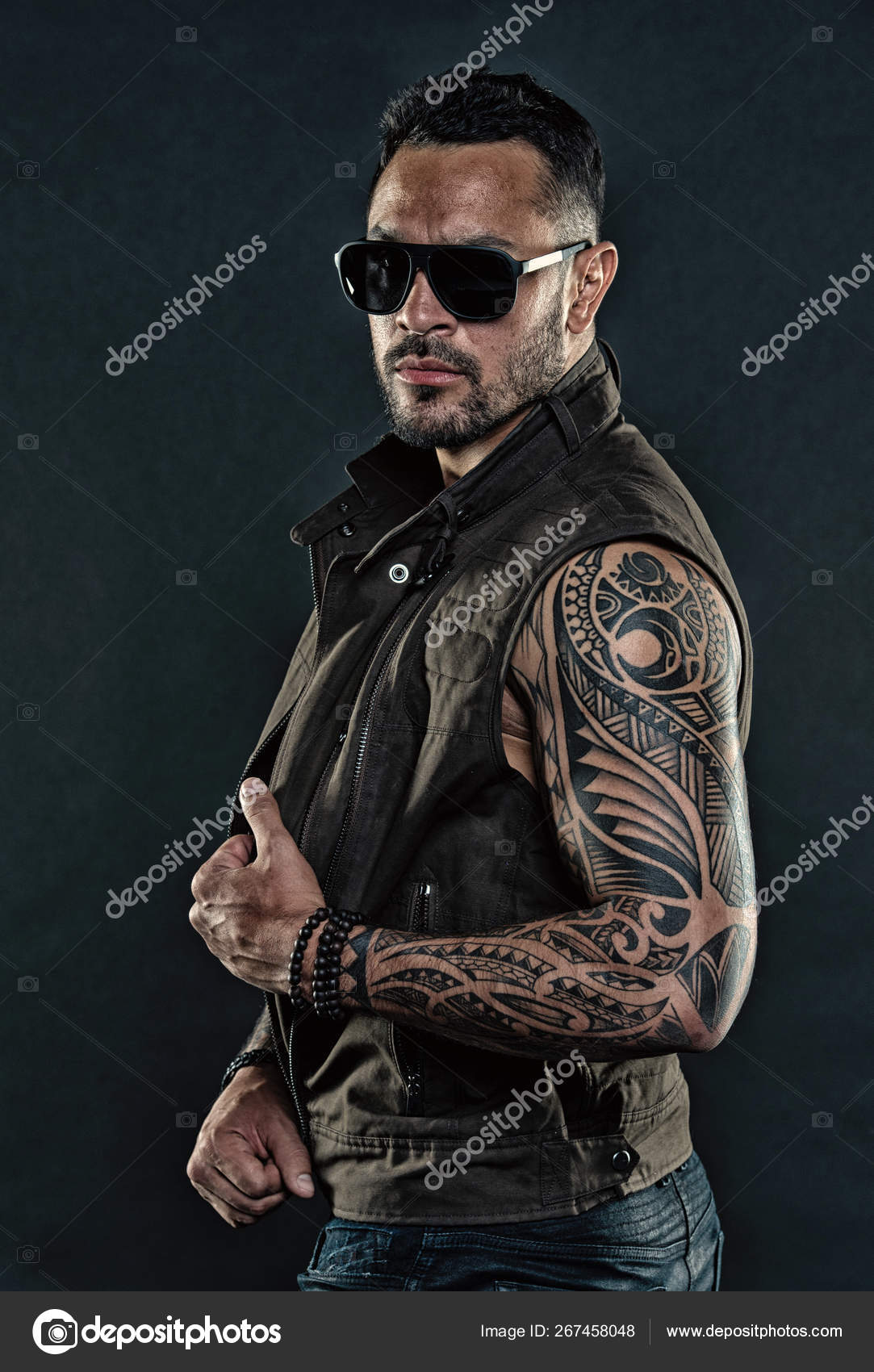 Tattoo model with beard on unshaven face. Bearded man with tattoo on ...