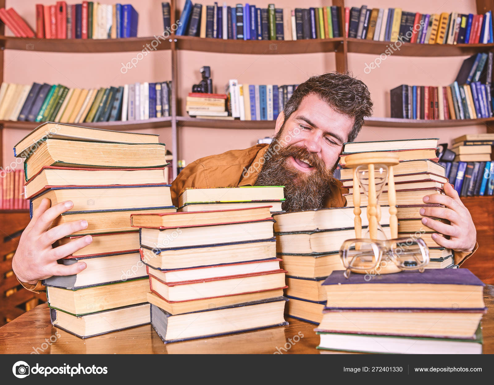 Librarian concept. Man on happy face between piles of books, while ...