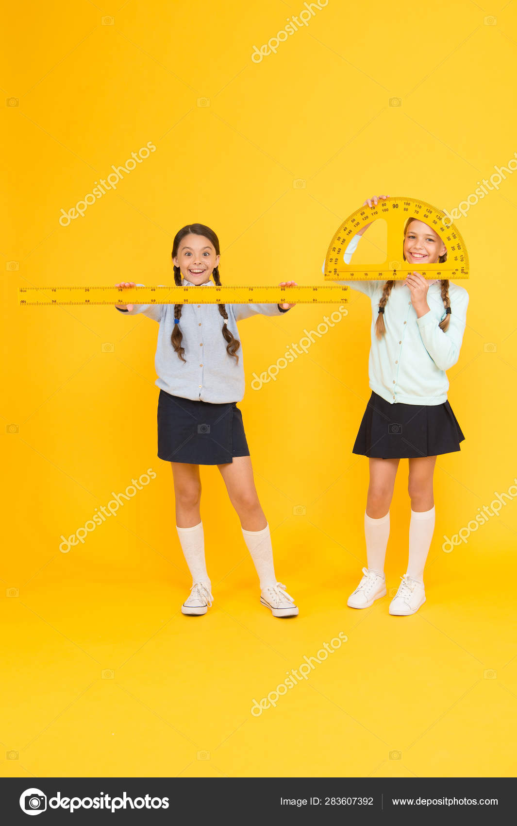 Learning school geometry. School children with measuring instruments on ...